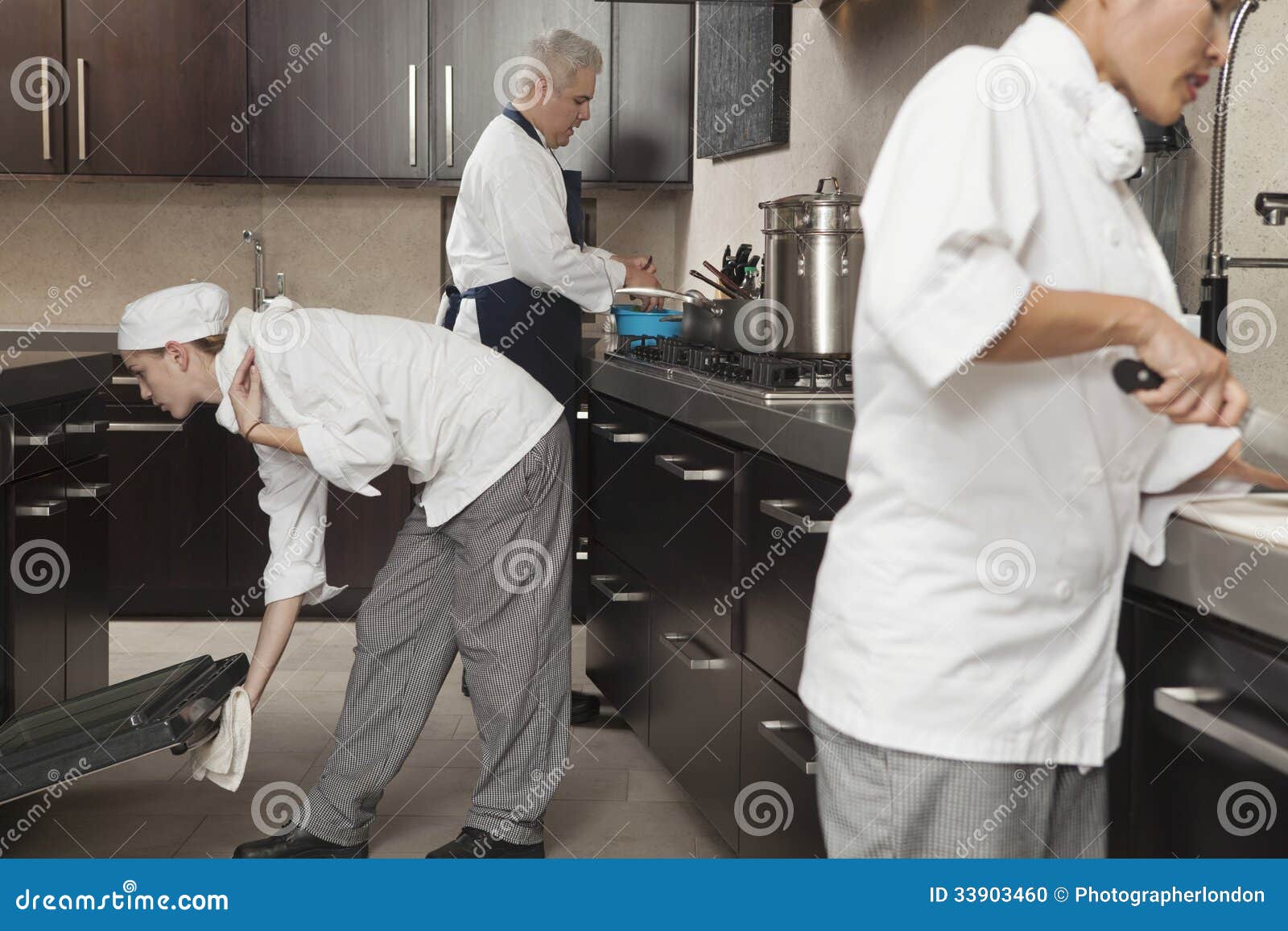 Chefs Working Together in Commercial Kitchen Stock Photo - Image of ...
