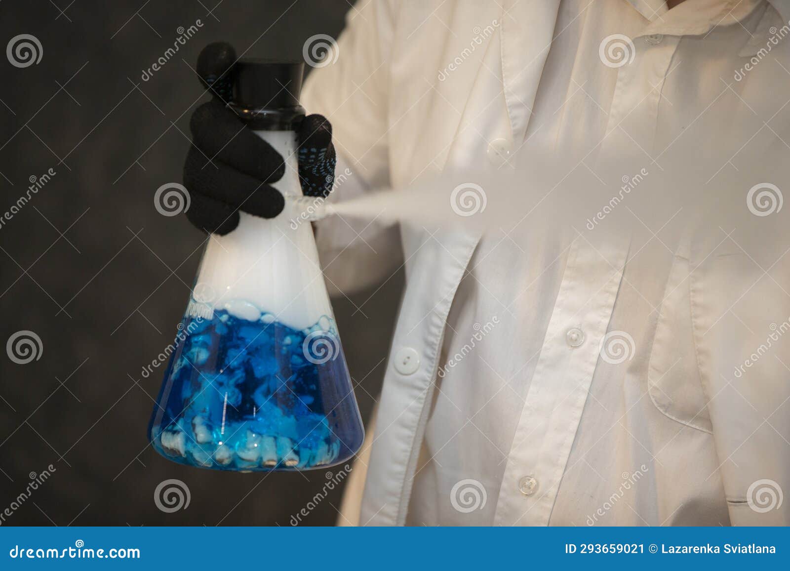 Chemical Flask with a Blue Solution in the Hands of a Laboratory ...