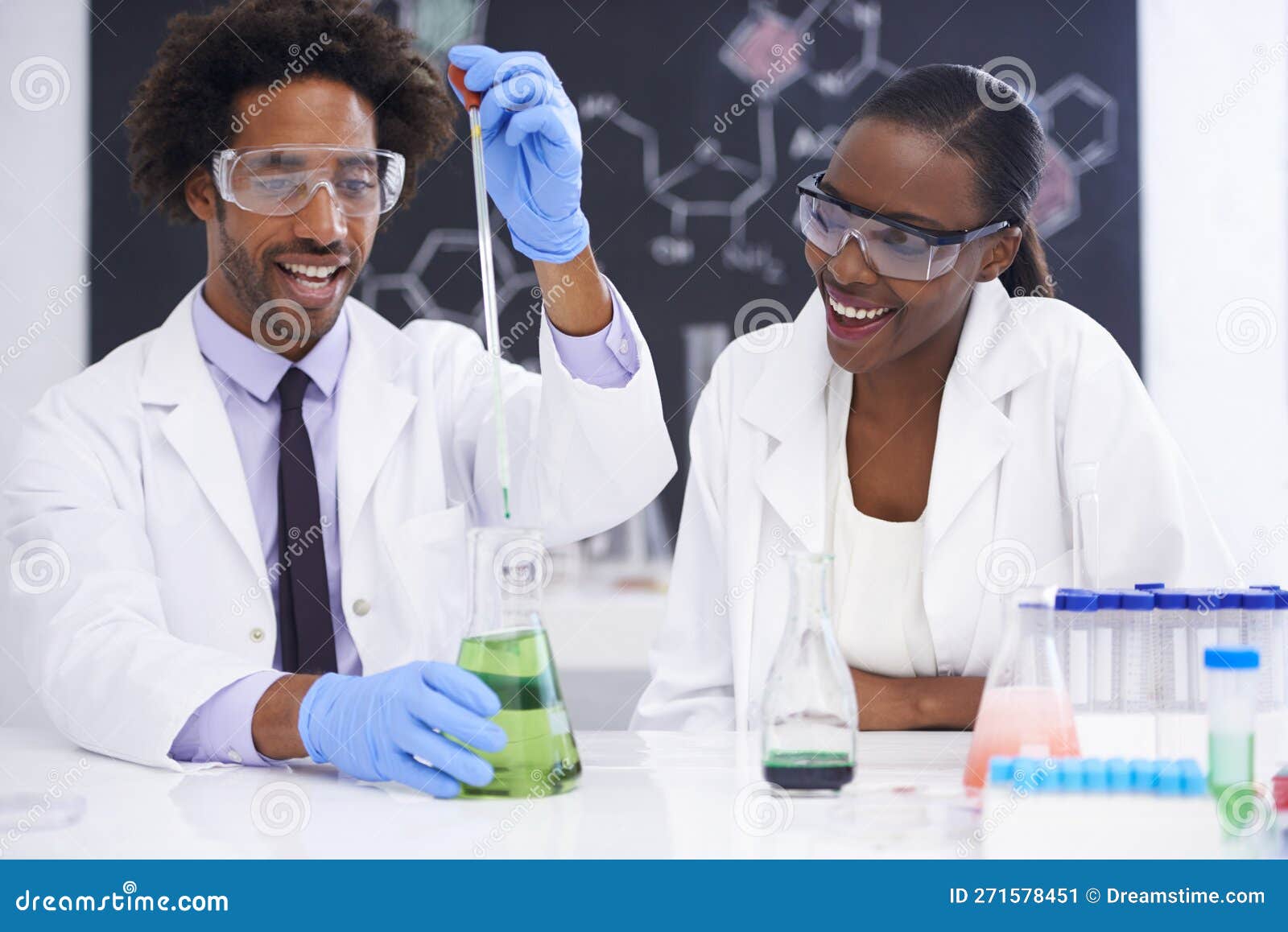 Chemical Fun. Two Scientists Conducting an Experiment with Various ...