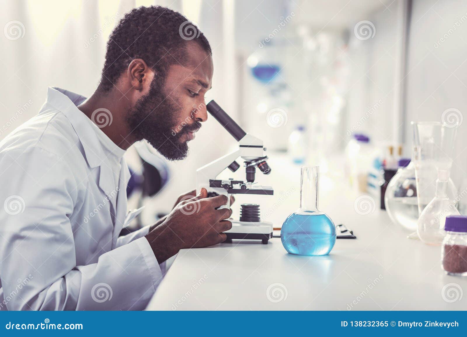 Young Chemical Practitioner Looking into Microscope Stock Image - Image ...