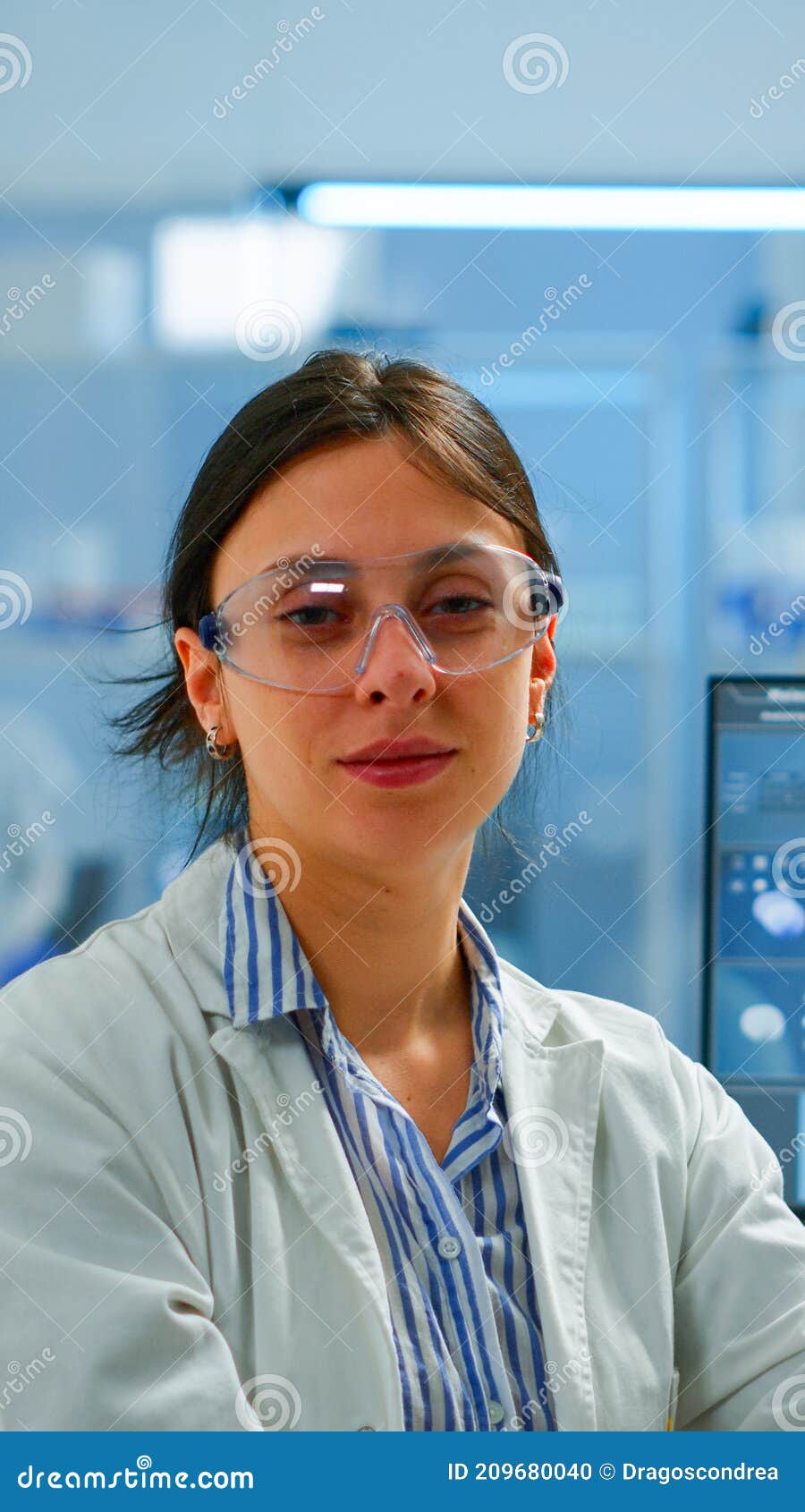 Chemist with Lab Coat Sitting in Laboratory Looking at Camera Smiling ...