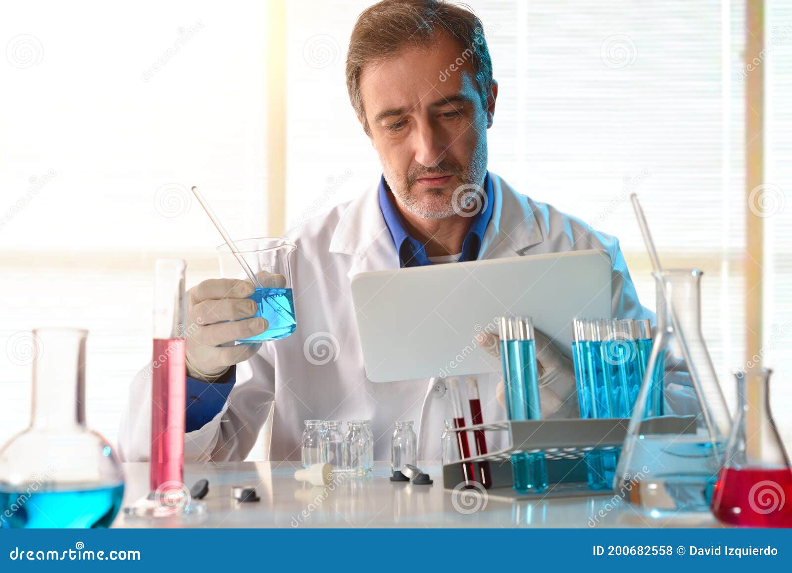 Chemist in a Laboratory Consulting a Tablet Front View Stock Photo ...