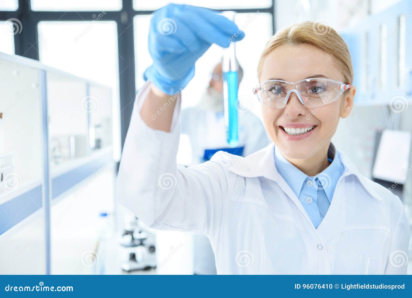 Chemist in Protective Eyeglasses Holding Test Tube with Reagent in Lab ...