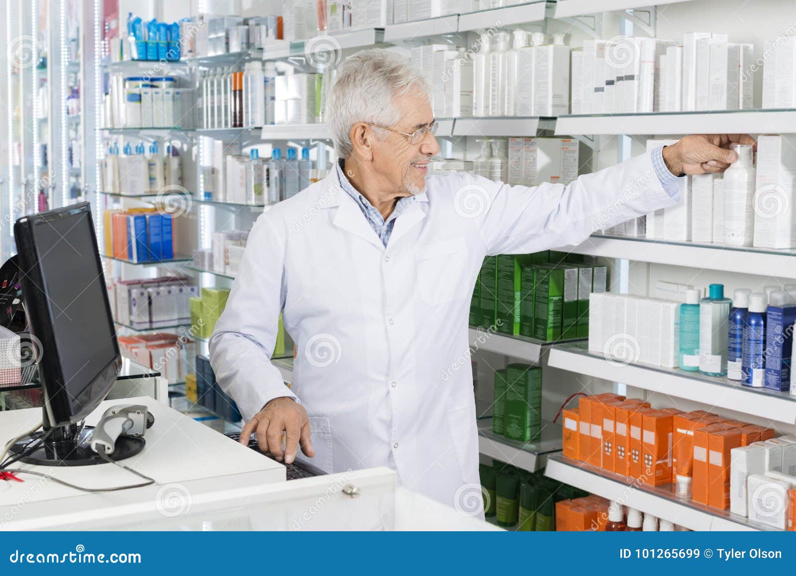 Chemist Removing Bottle from Shelf while Working on Computer Stock ...