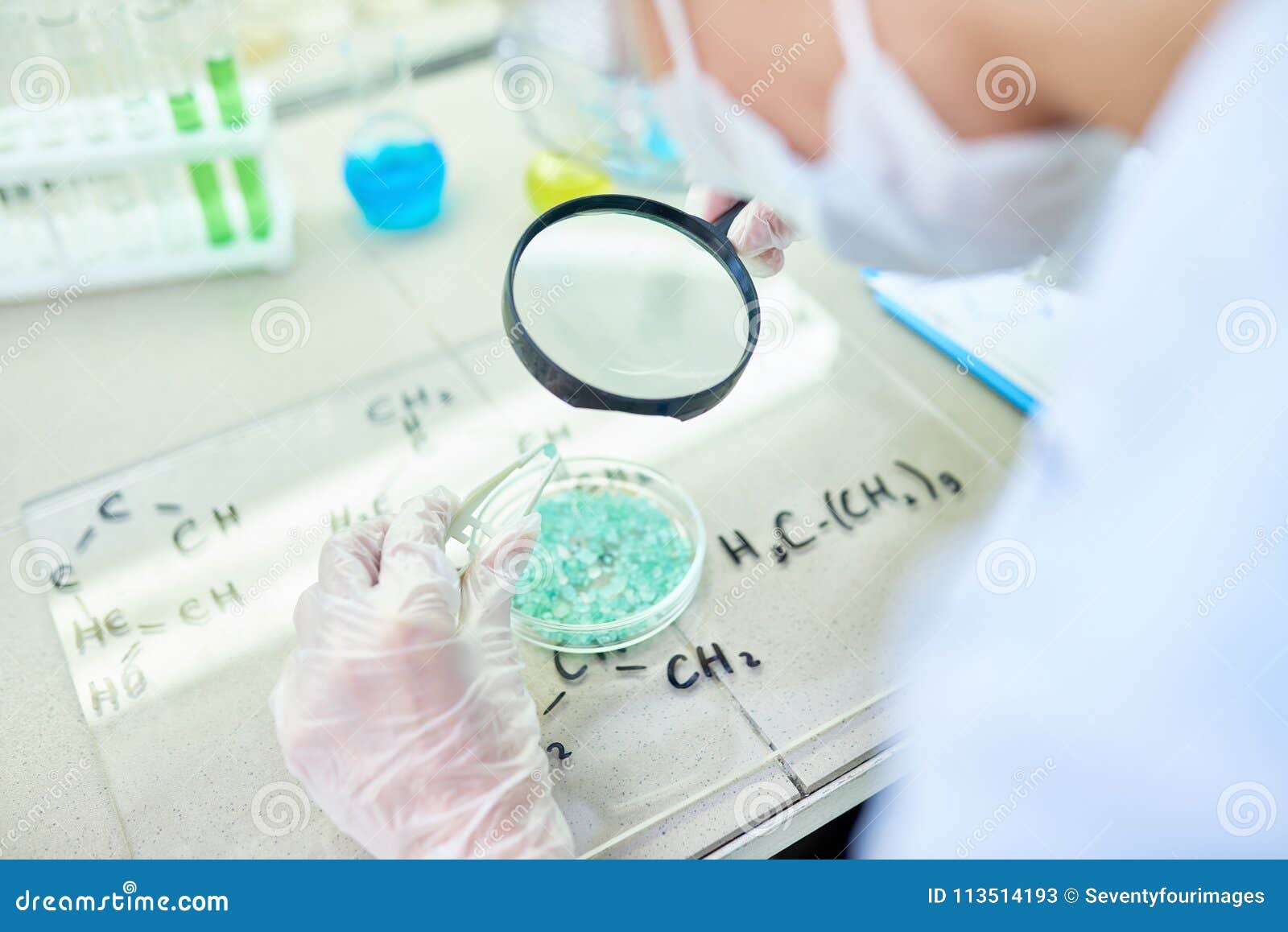 Chemist Viewing Blue Crystal through Magnifying Glass Stock Image ...