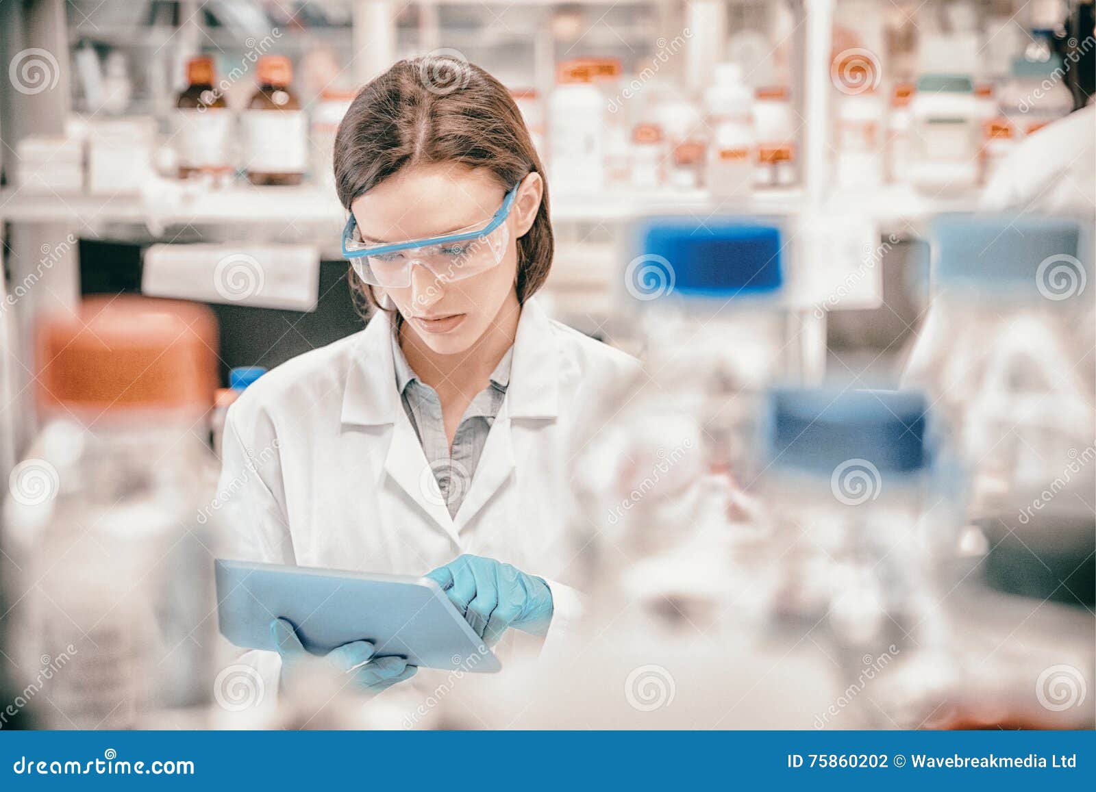 Chemist Wearing Safety Glasses and Using Tablet Pc Stock Photo - Image ...