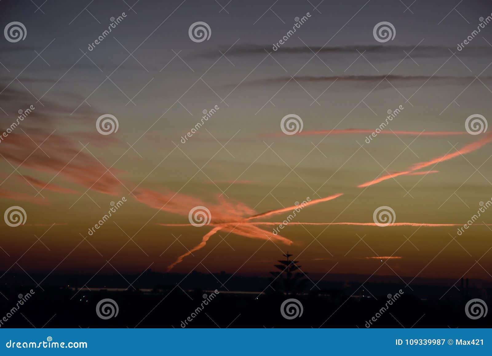 Chem trails in evening sky stock image. Image of sunset - 109339987