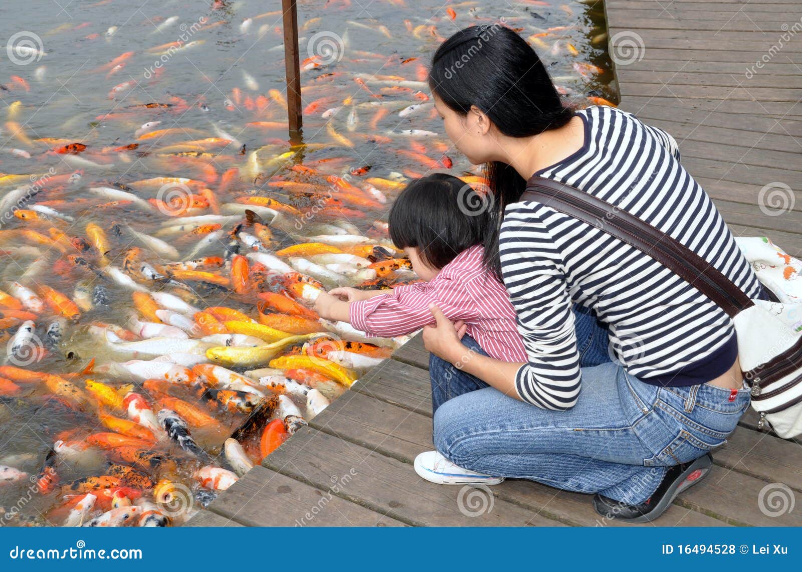 Chengdu, China: Mother and Daughter Feeding Fish Editorial Stock Photo ...