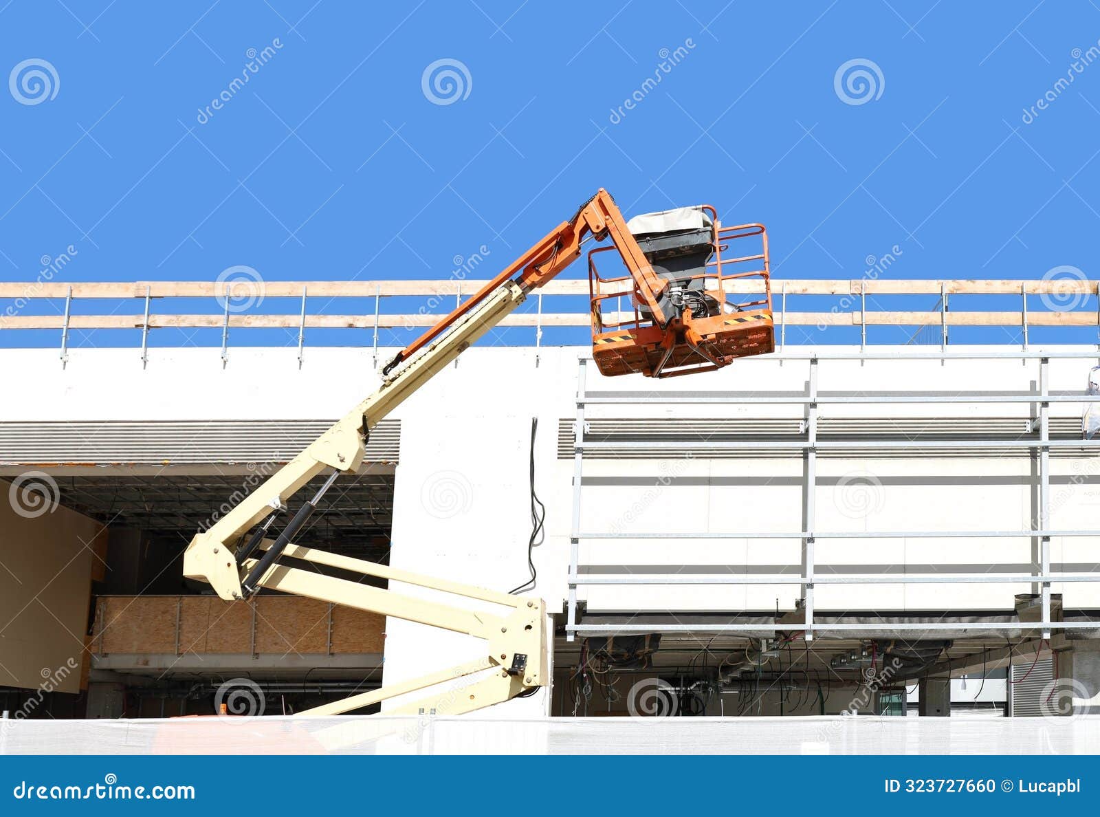 Cherry Picker in Front a Facade of New Building Under Construction ...