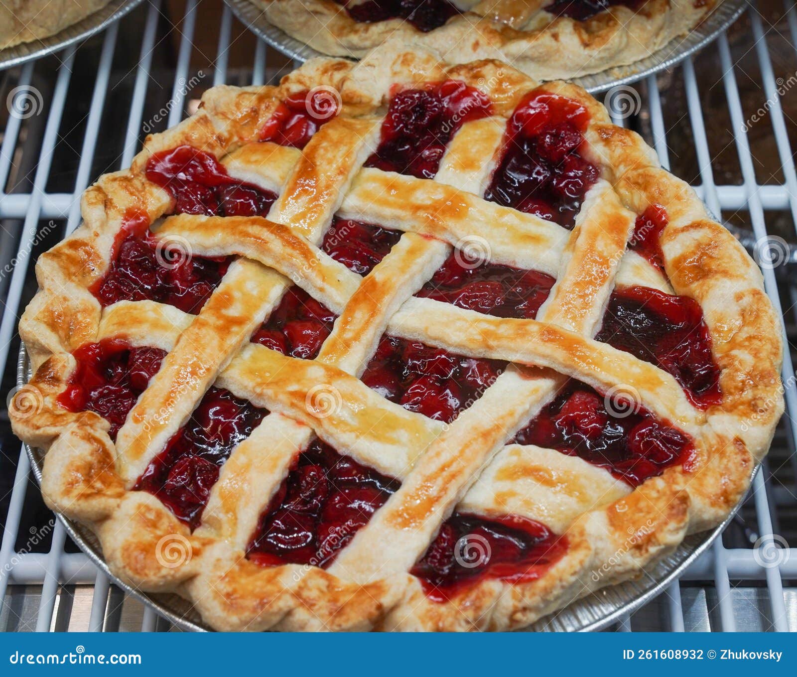 Cherry pie in local bakery stock photo. Image of cream - 261608932