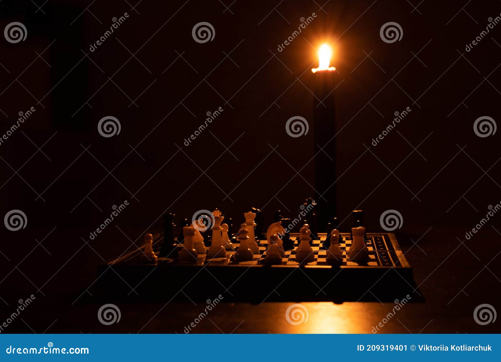 Chess Board with Chess in the Dark with Candles in the Room Stock Image ...