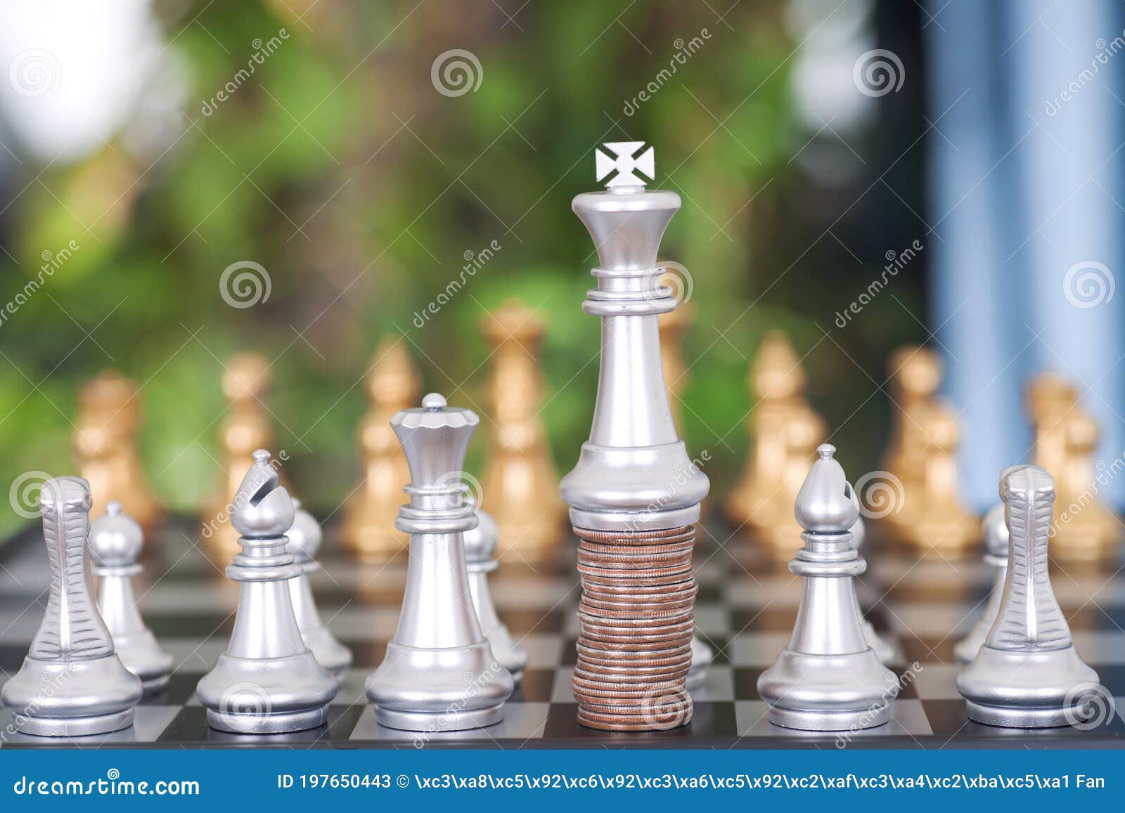 Chess Pieces on a Chess Board with Silver King Pieces on a Stack of ...