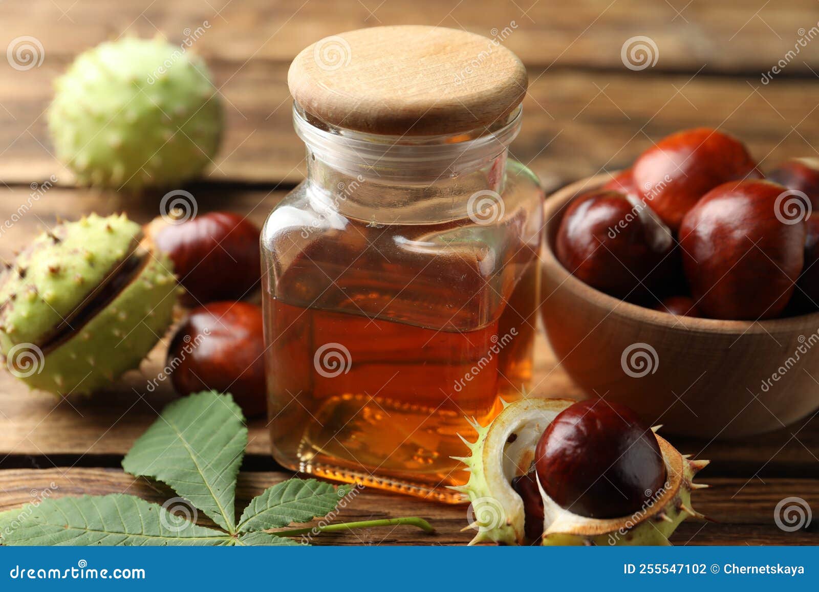 Chestnuts and Jar of Essential Oil on Wooden Table Stock Photo - Image ...