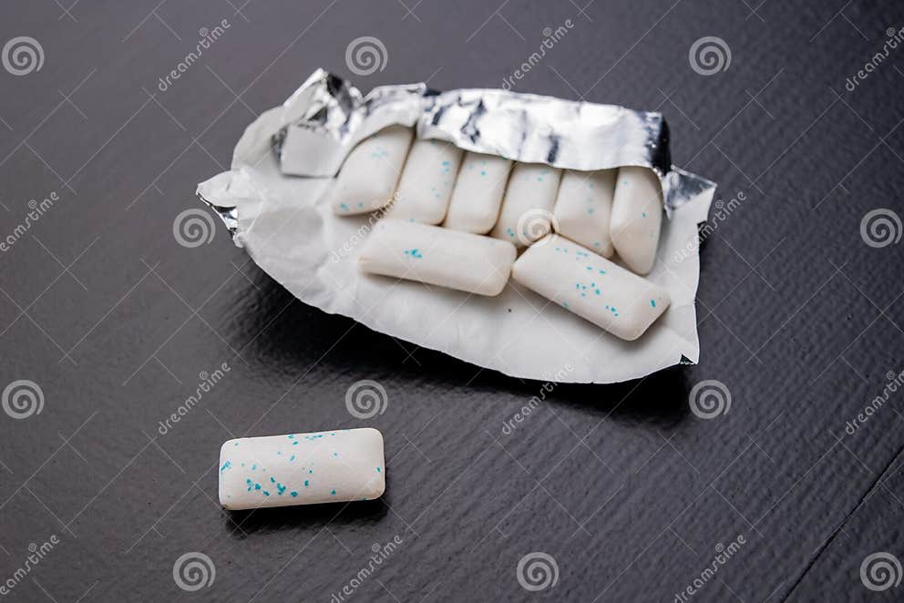 Chewing Gum on the Table. Mint Refreshing Tablet in a Silver Package ...