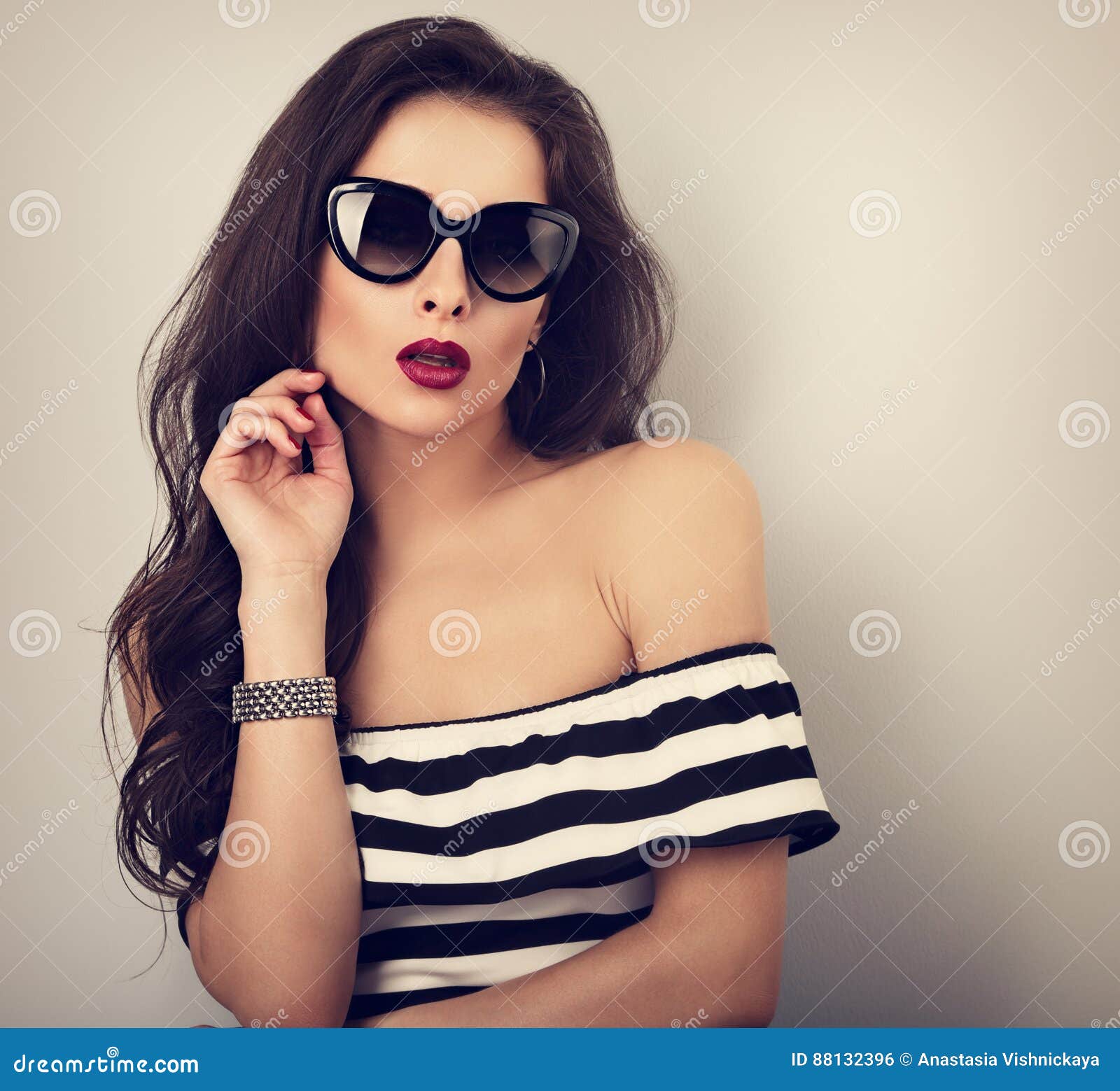 Chic Female Model With Long Hair Posing In Fashion Sunglasses In Stock