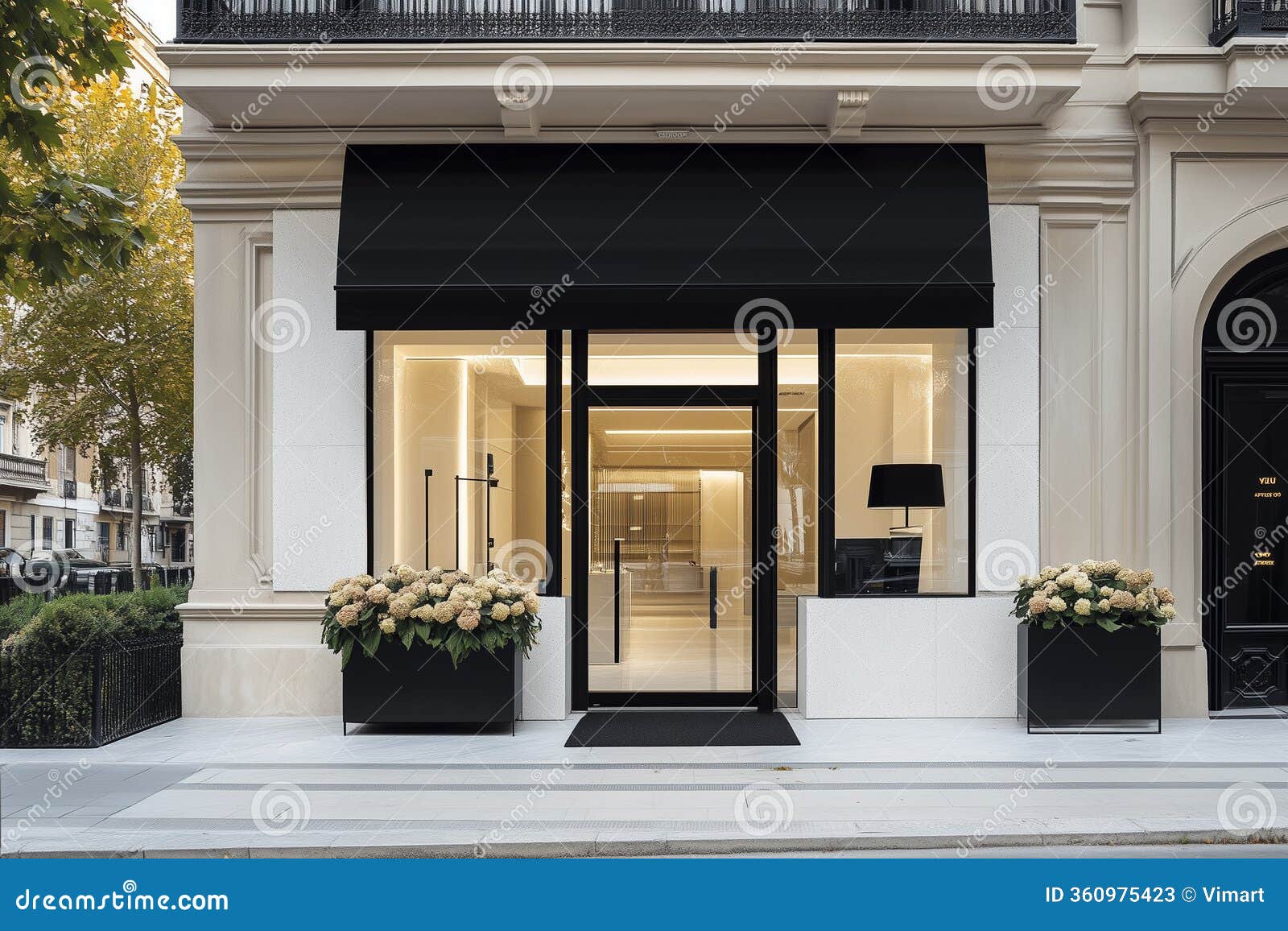 Chic Storefront with Black Awning and Floral Displays Stock Image ...