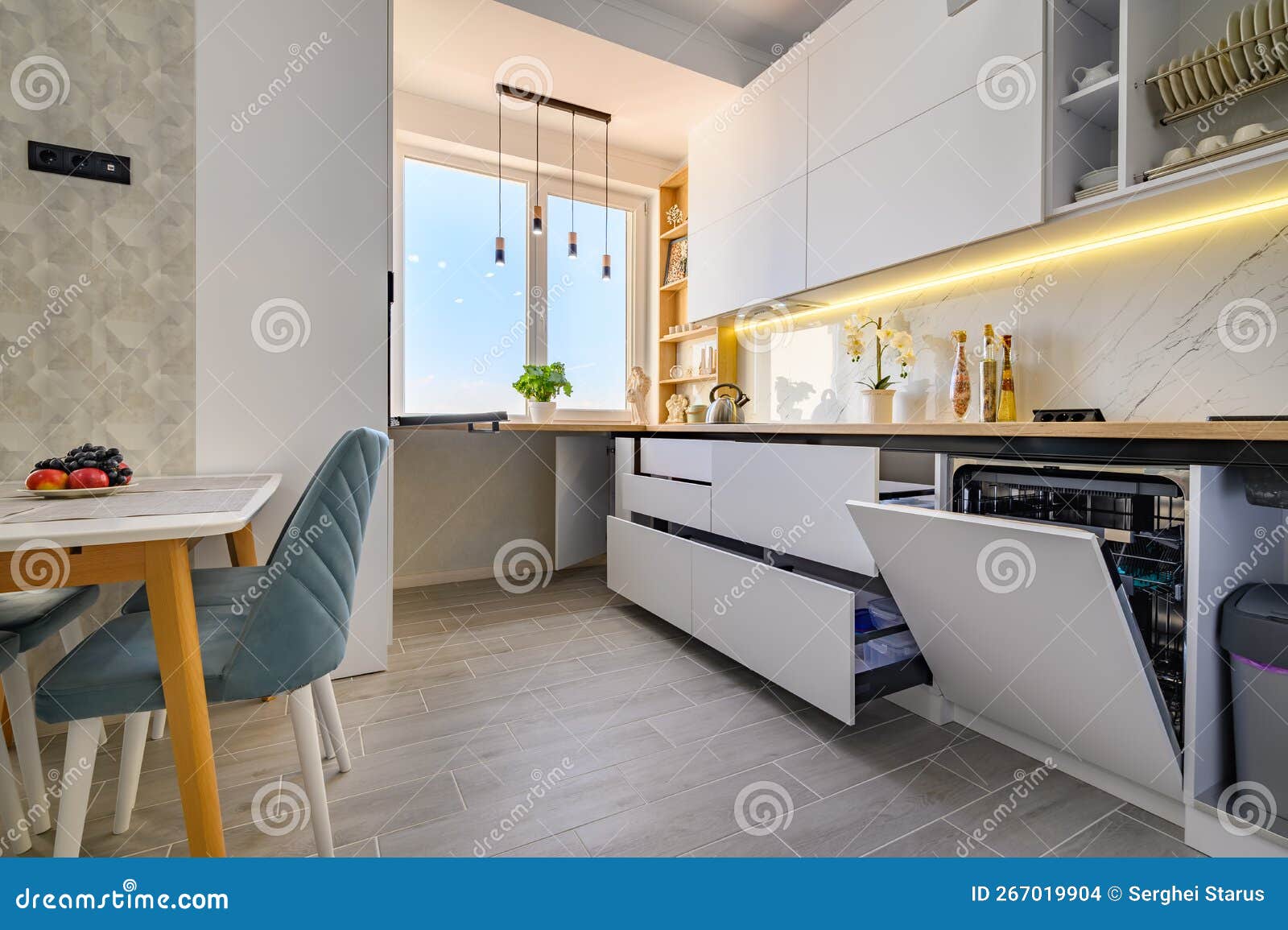 A Chic White Kitchen with Drawers Fully Extended Stock Photo - Image of ...