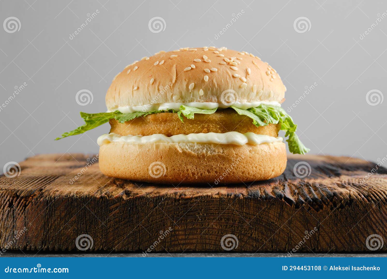 Chicken Burger with Fresh Iceberg Lettuce on Wooden Board, Front View ...