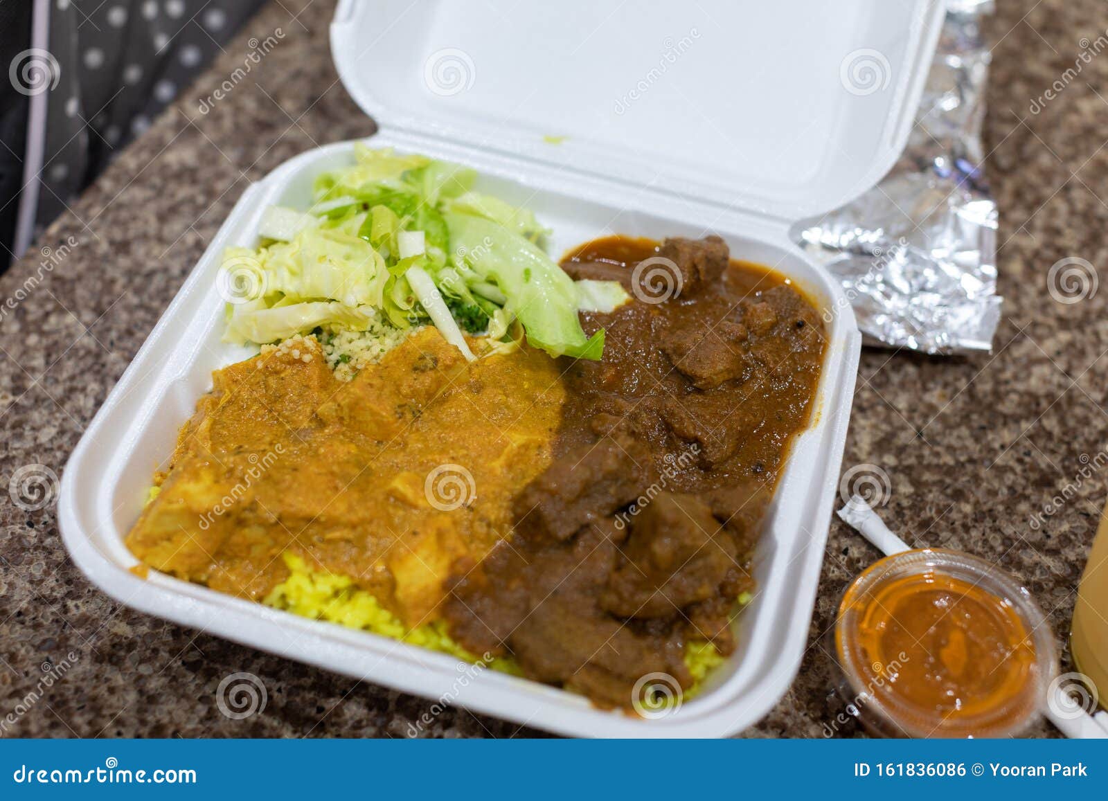 Chicken Curry and Ramp Curry with Yellow Rice in a White Plastic ...