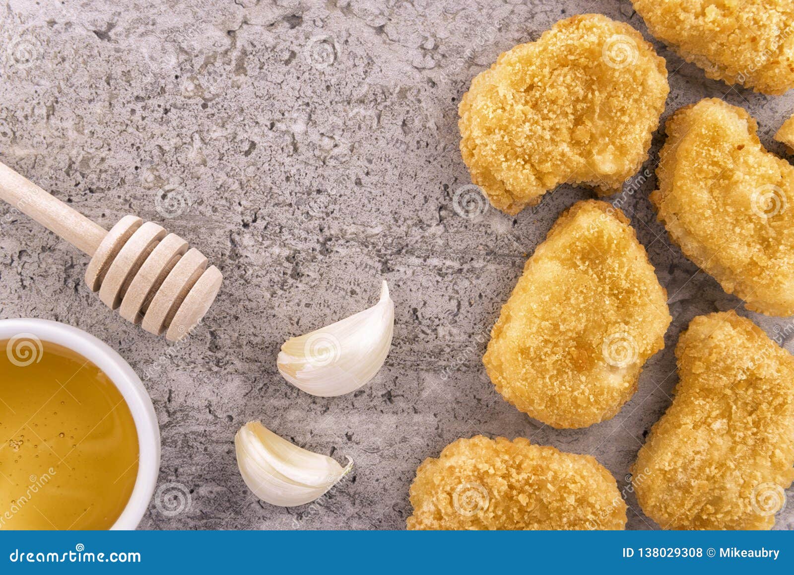Chicken Nuggets with Garlic and Honey on a Concrete Texture Background ...