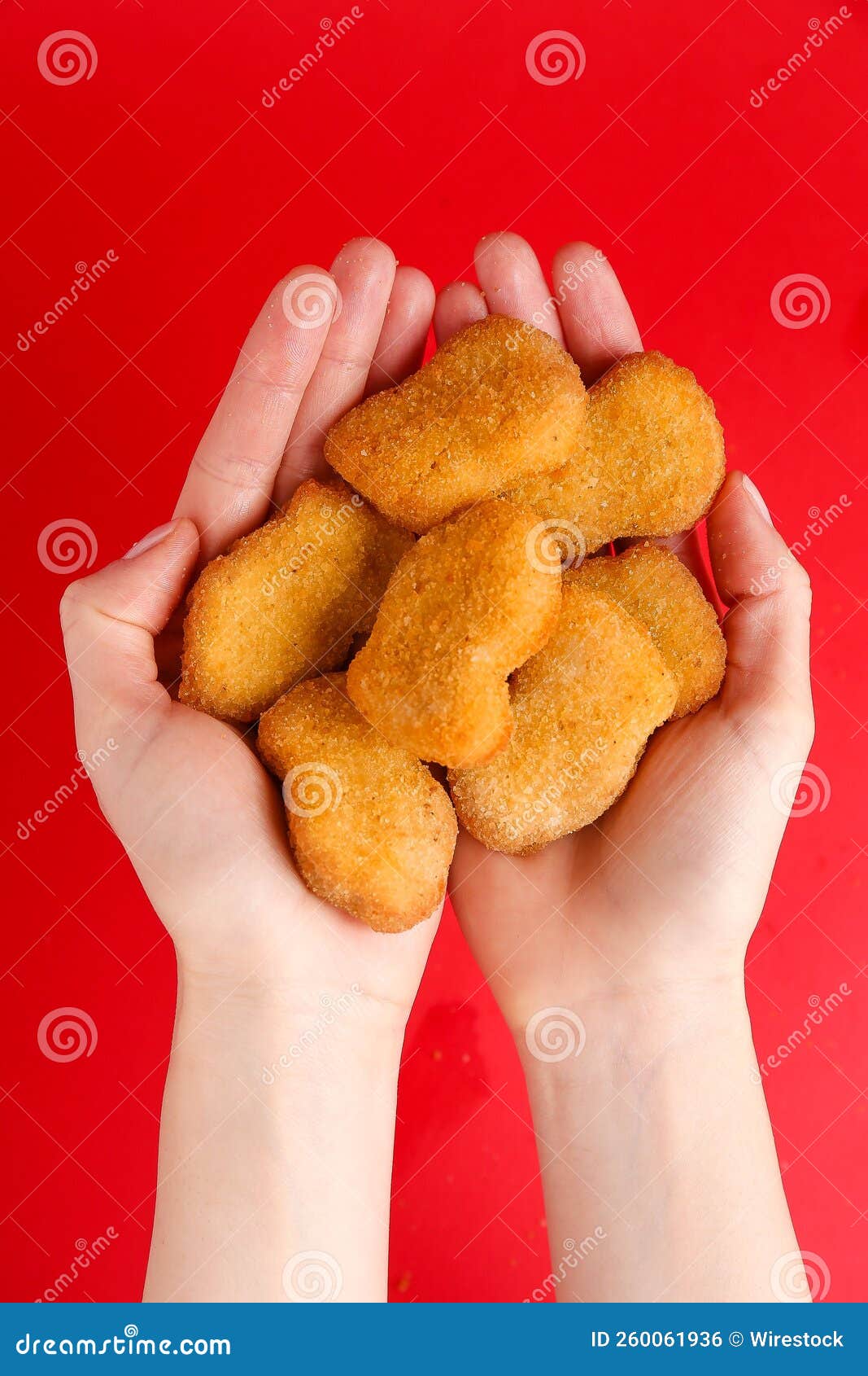 Chicken Nuggets on the Hand Palms, Isolated on Red Background, Vertical ...