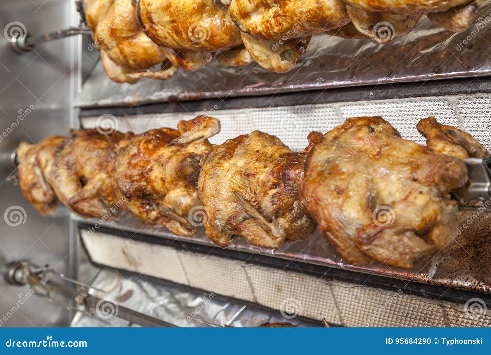 Chicken on spit roaster stock photo. Image of skewer - 95684290