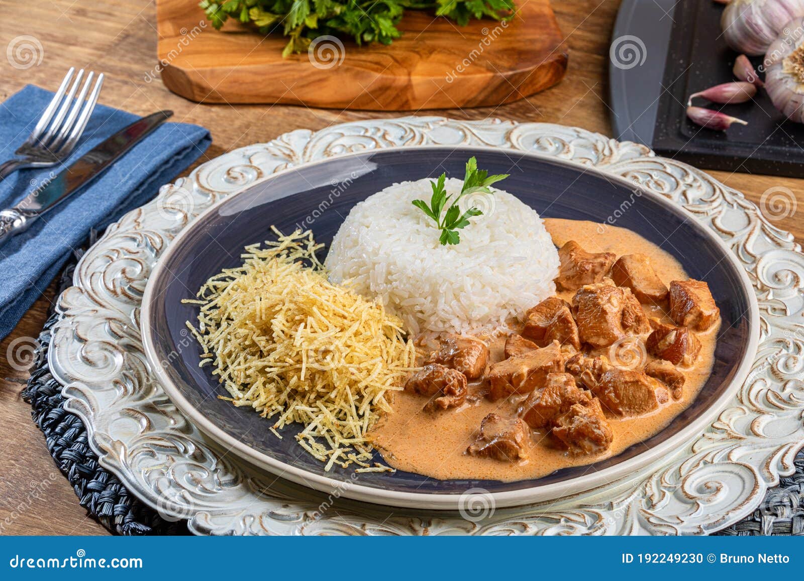 Chicken Stroganoff with Rice and Potato Straw Stock Photo - Image of ...