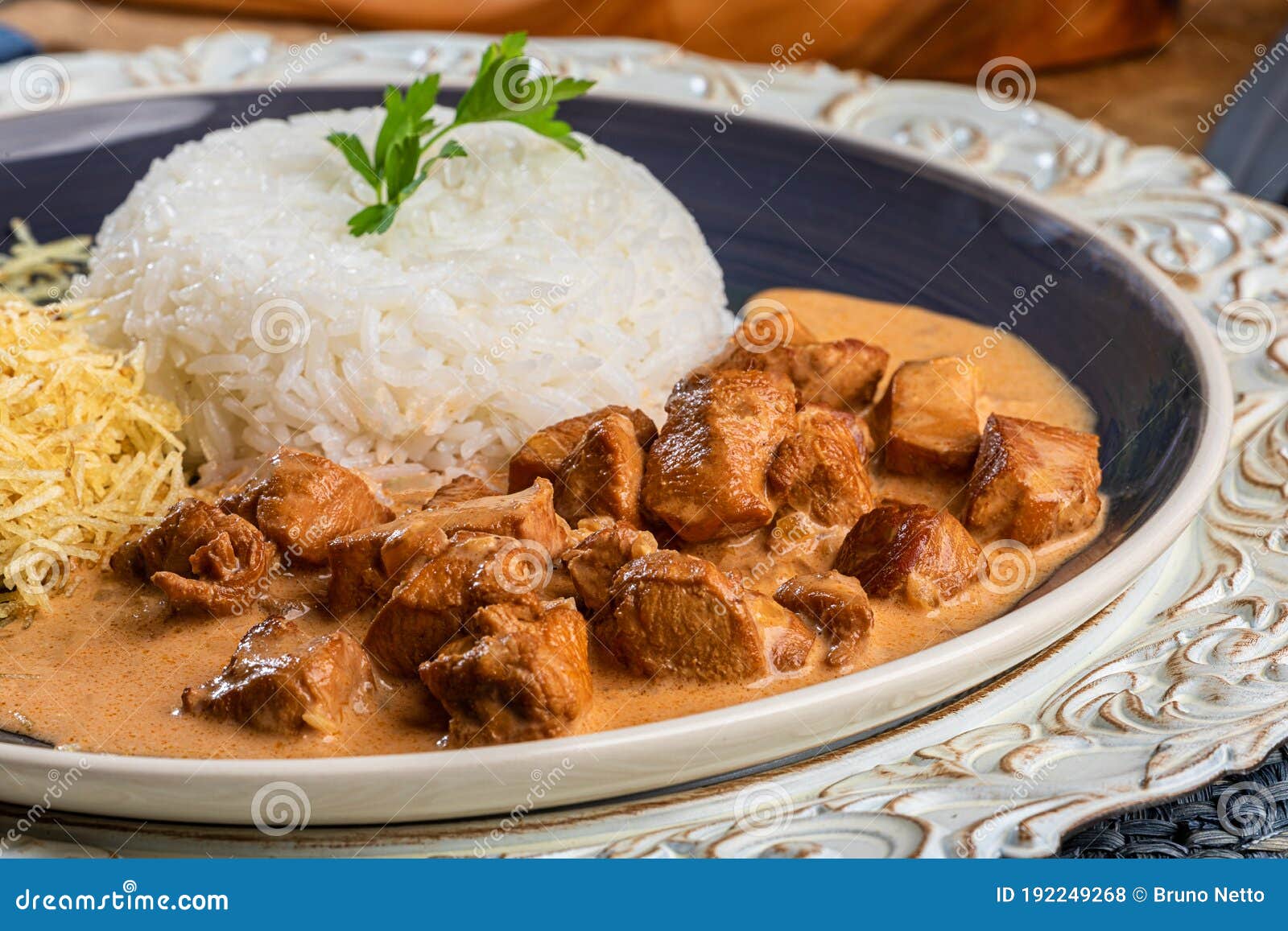 Chicken Stroganoff with Rice and Potato Straw Stock Photo - Image of ...
