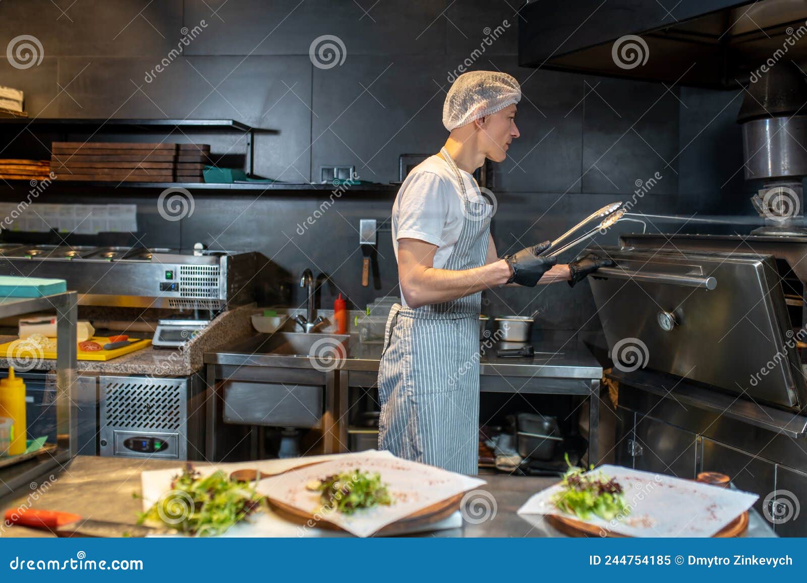 A Chief-cooker Working in the Kitchen in the Restaurant Stock Image ...