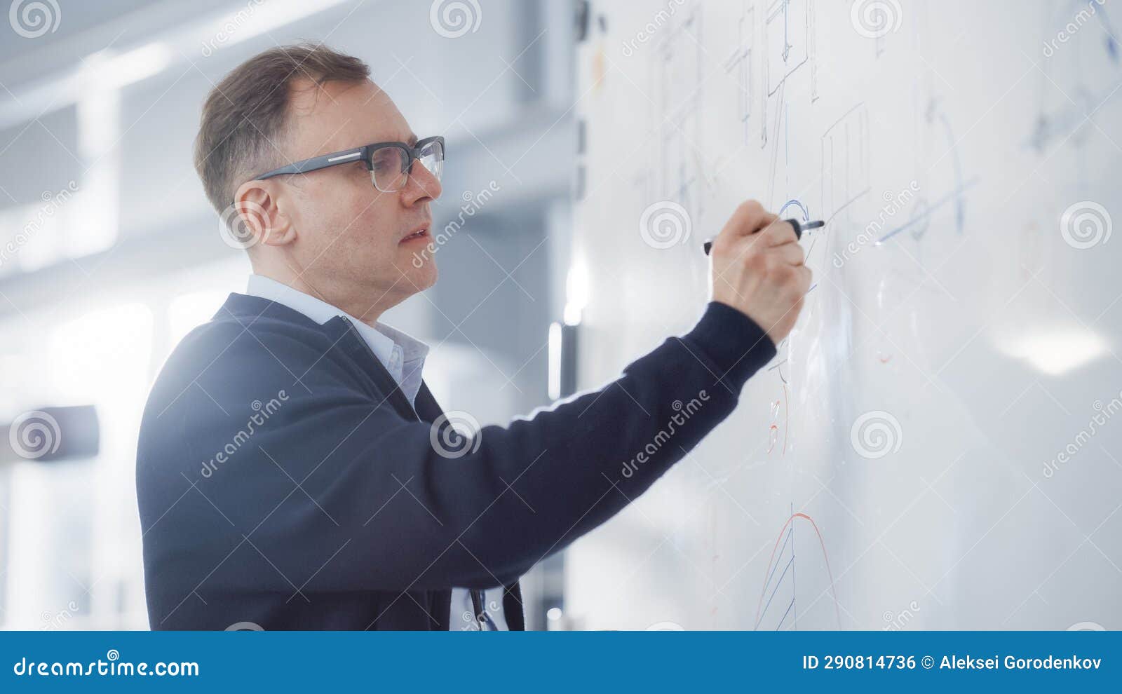 Chief Engineer Drawing Graphs on a Whiteboard during University Lesson ...