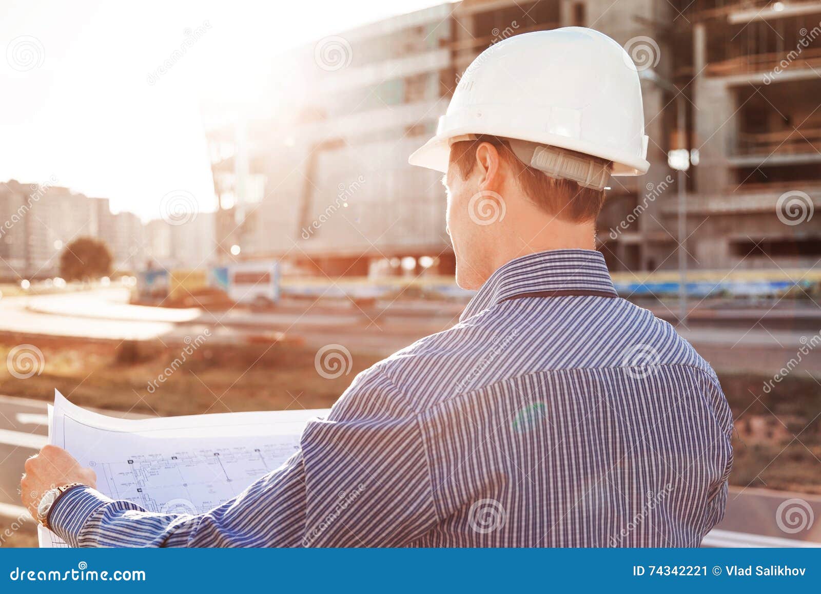 Chief Engineer with a Drawing in Hand Looking at the Construction Site ...