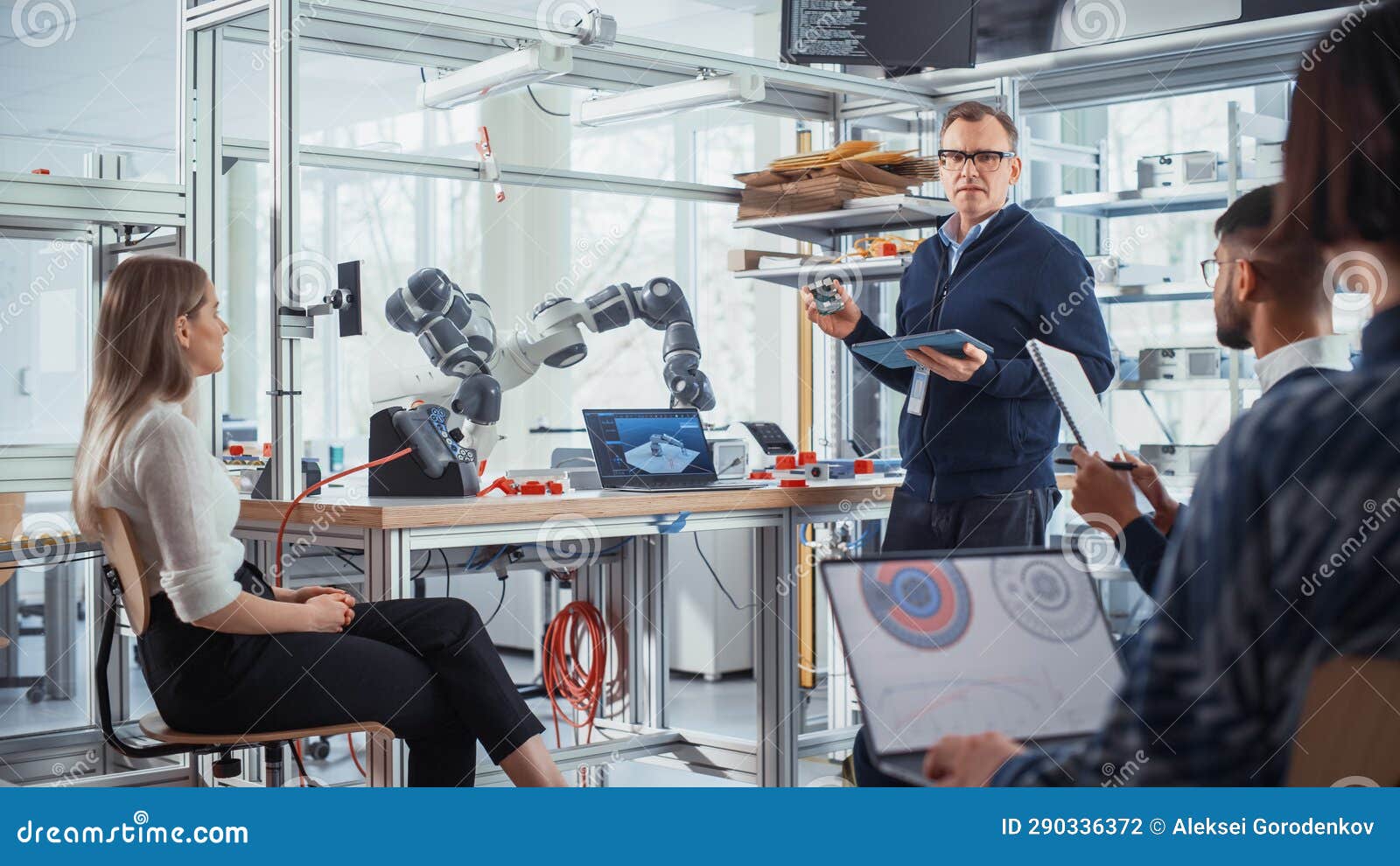 Chief Engineer Holds Tablet and Talks To Diverse Team of Computer ...