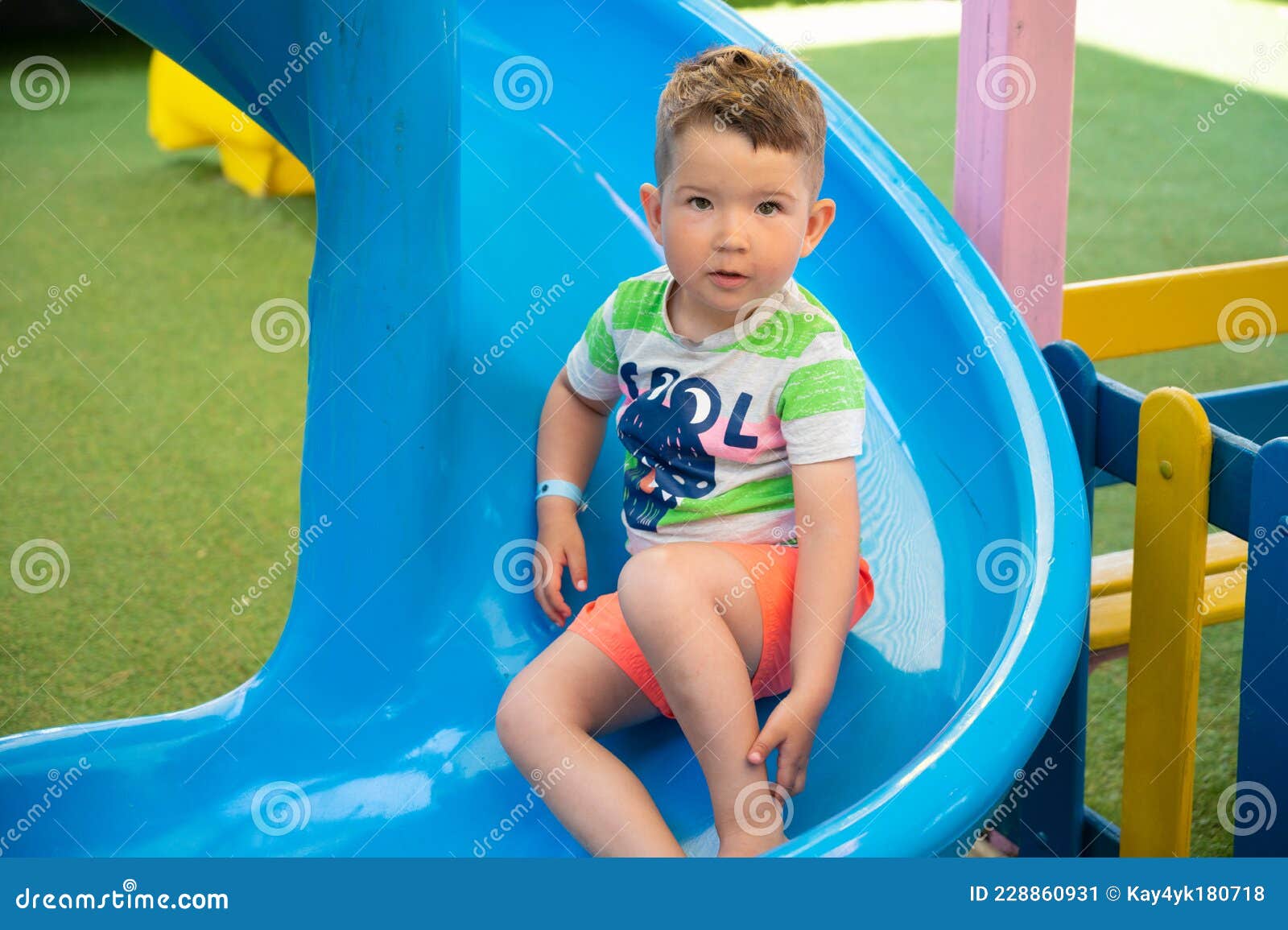 The Child is Afraid of Rolling Down the Children S Slide Stock Image ...