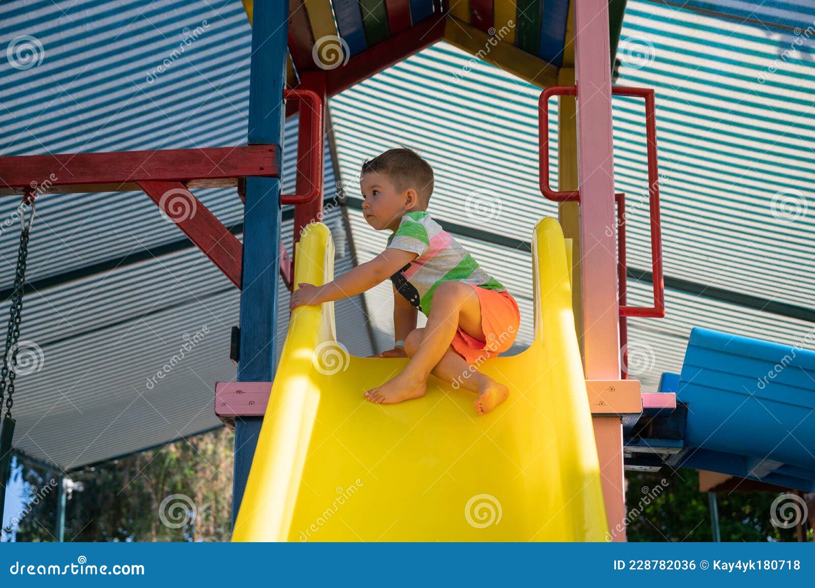 The Child is Afraid of Rolling Down the Children& X27;s Slide Stock ...