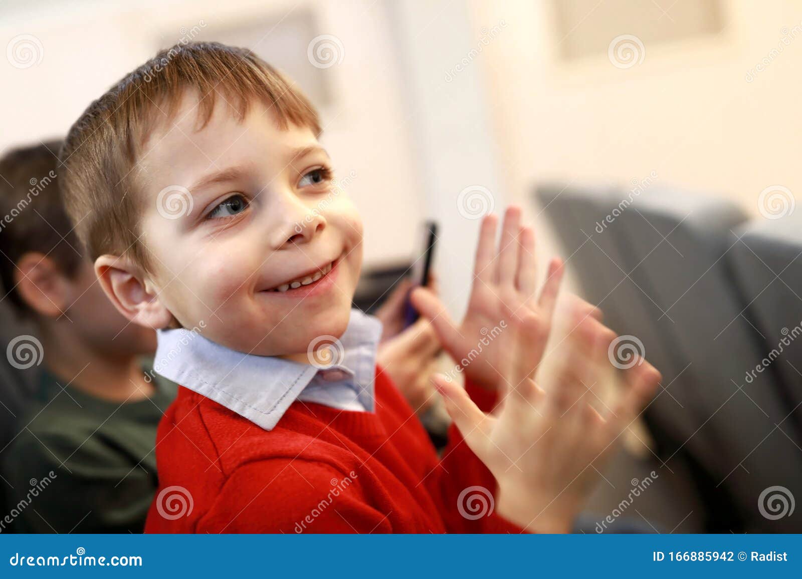 Child applauds in theater stock photo. Image of happiness - 166885942
