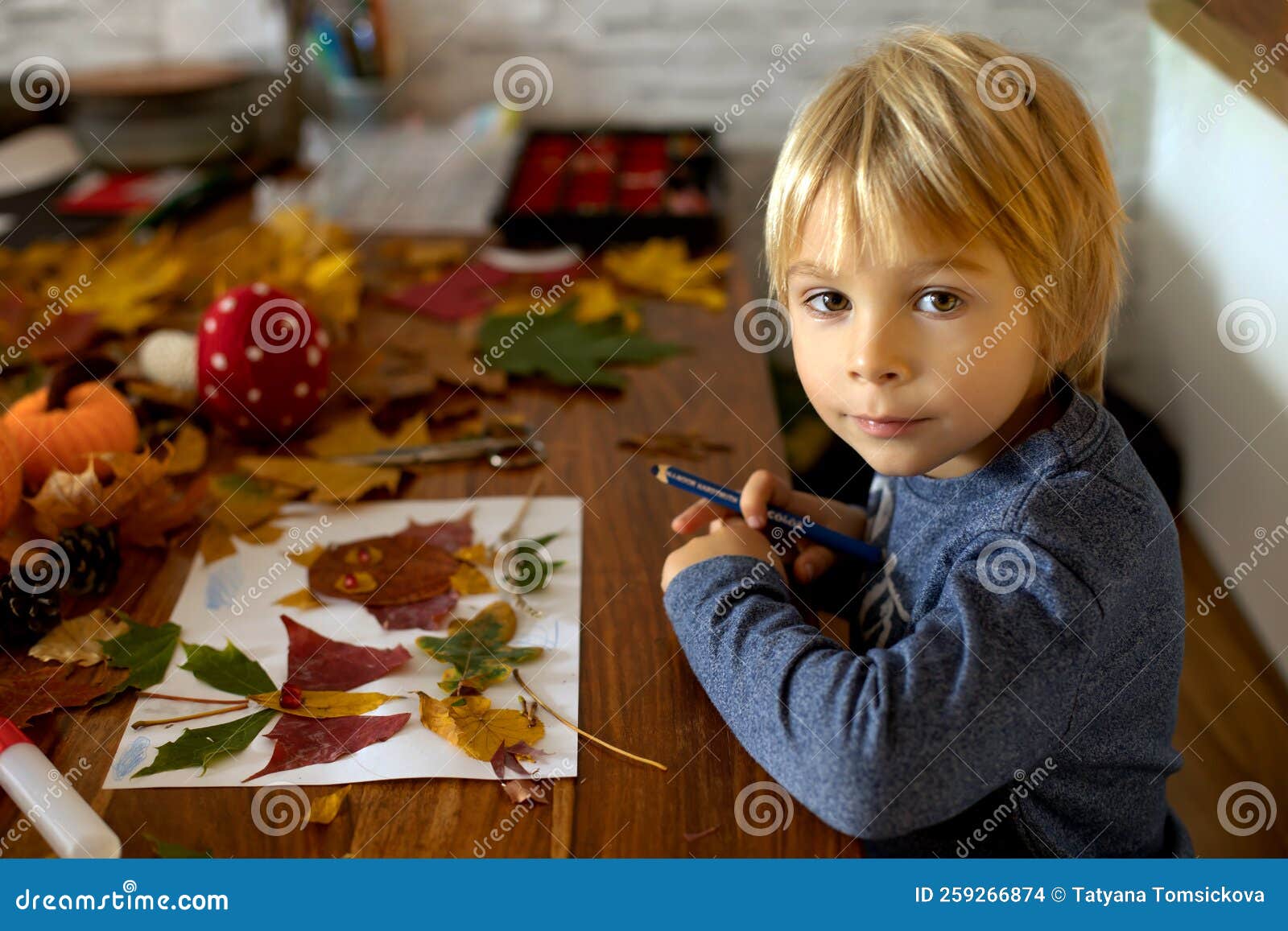 Child, Applying Leaves Using Glue, Scissors, and Paint, while Doing ...