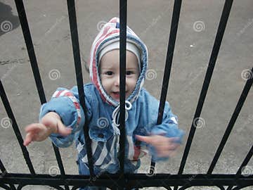 Child behind gate stock photo. Image of face, childhood - 2058956