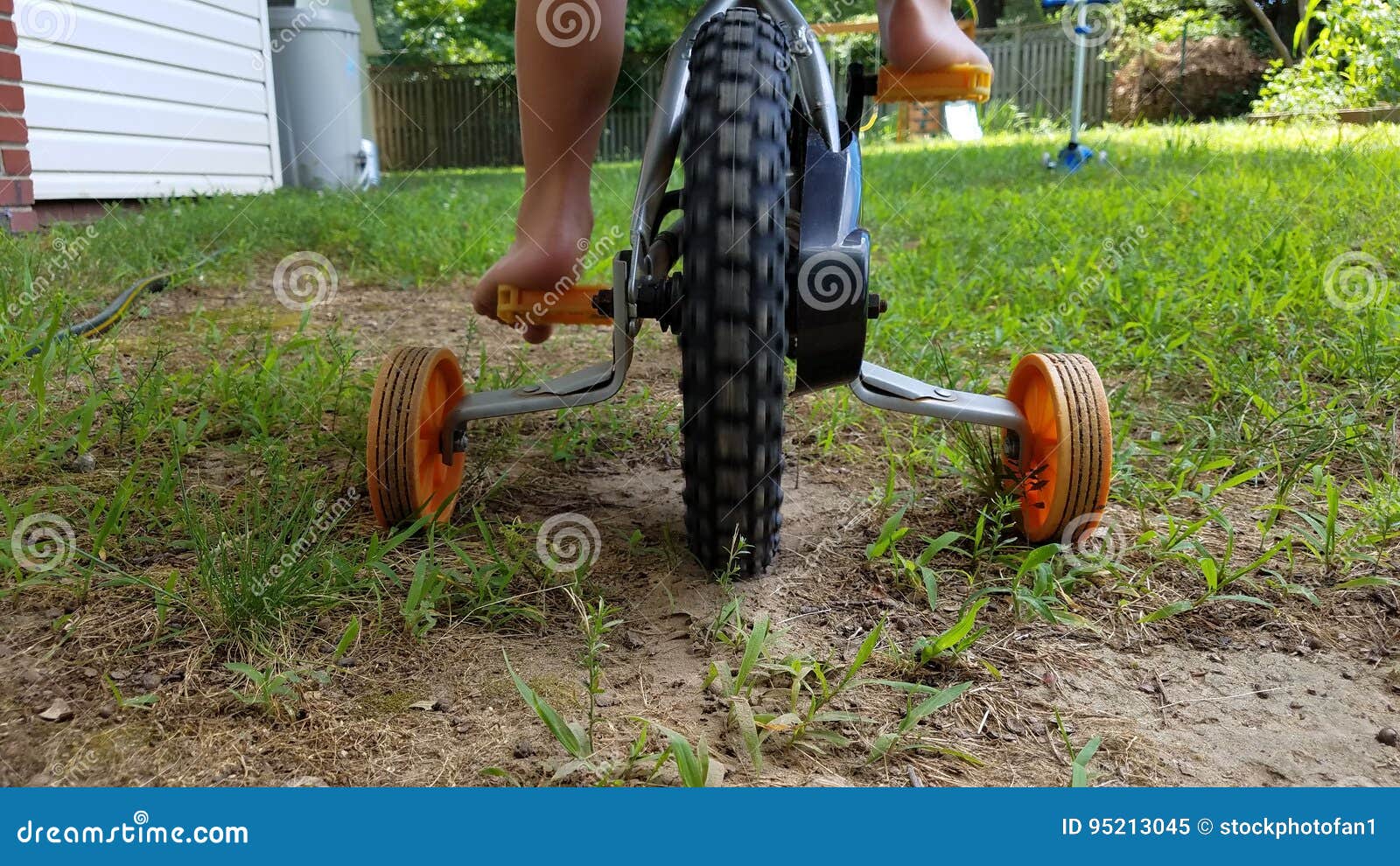 Child on Bike with Training Wheels in Dirt Stock Image - Image of child ...