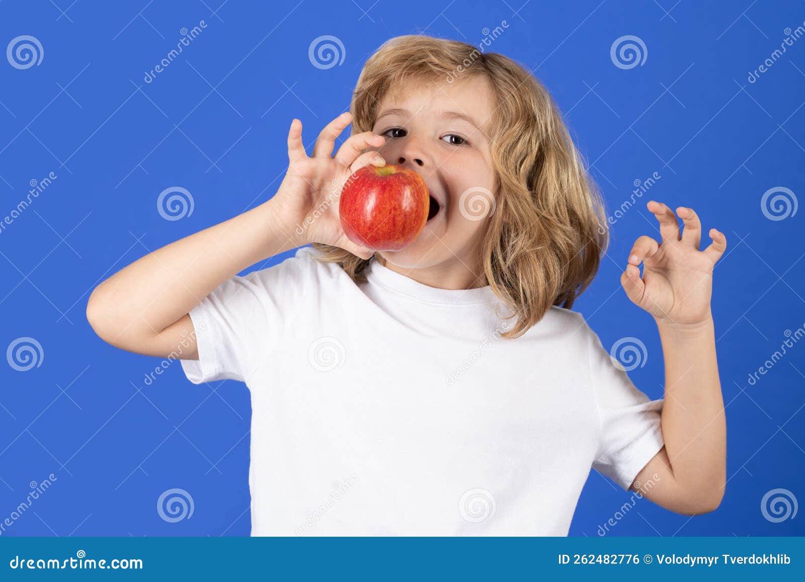 Child Biting Apple on Studio Isolated Background. Stock Photo - Image ...