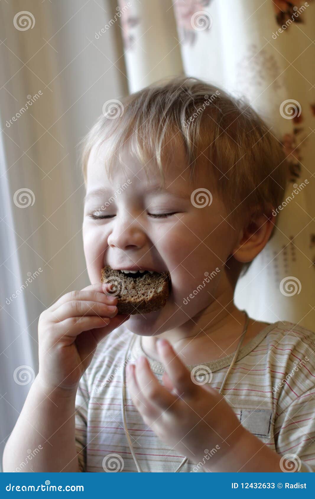 Child biting bread stock image. Image of male, little - 12432633