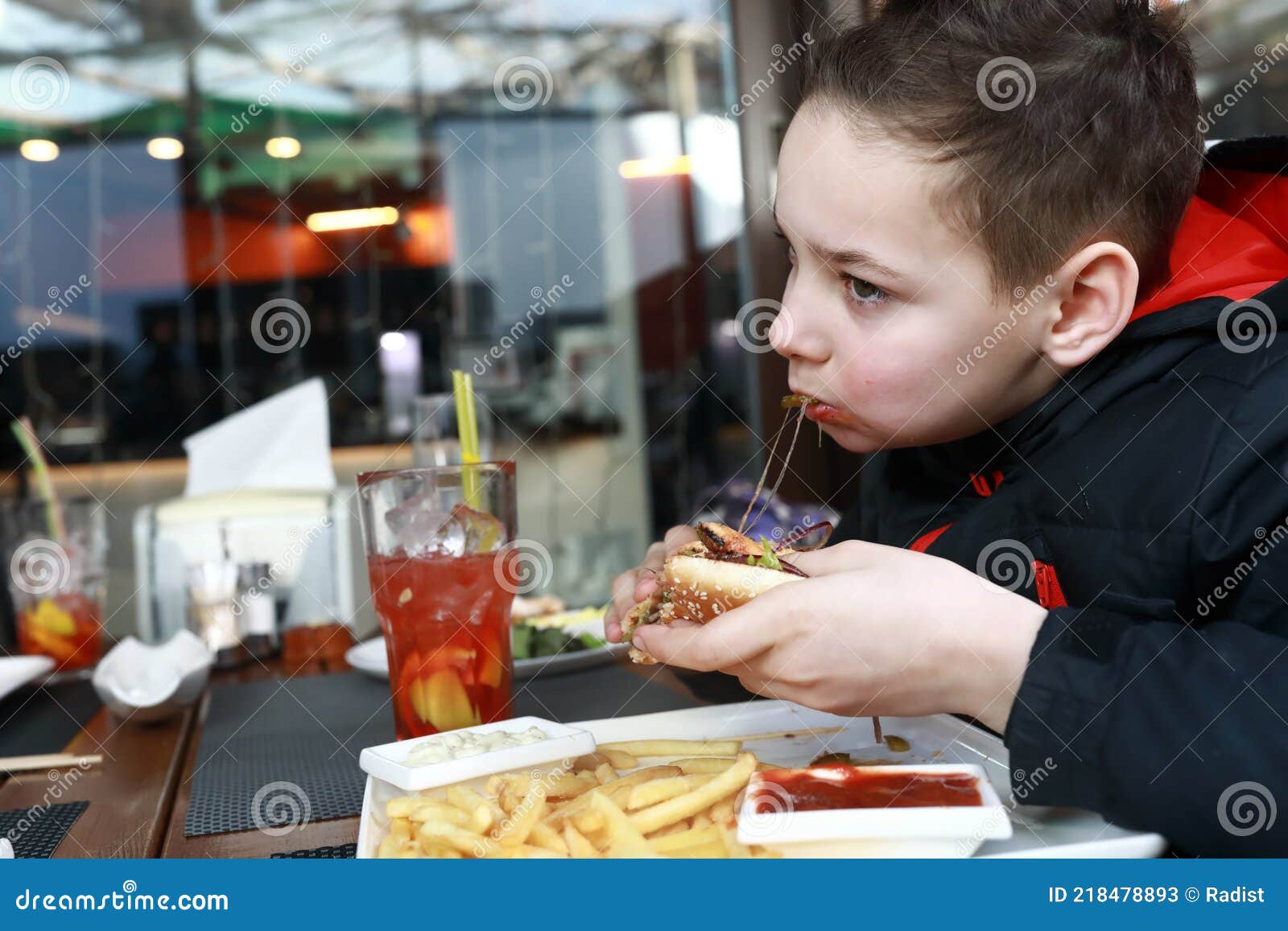 Child Biting Burger on Restaurant Terrace Stock Image - Image of food ...