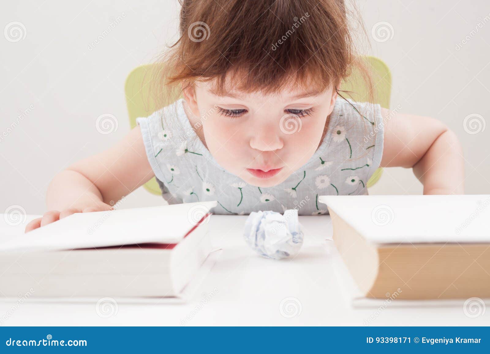 The Child Blows on a Ball of Paper at the Table. Stock Image - Image of ...