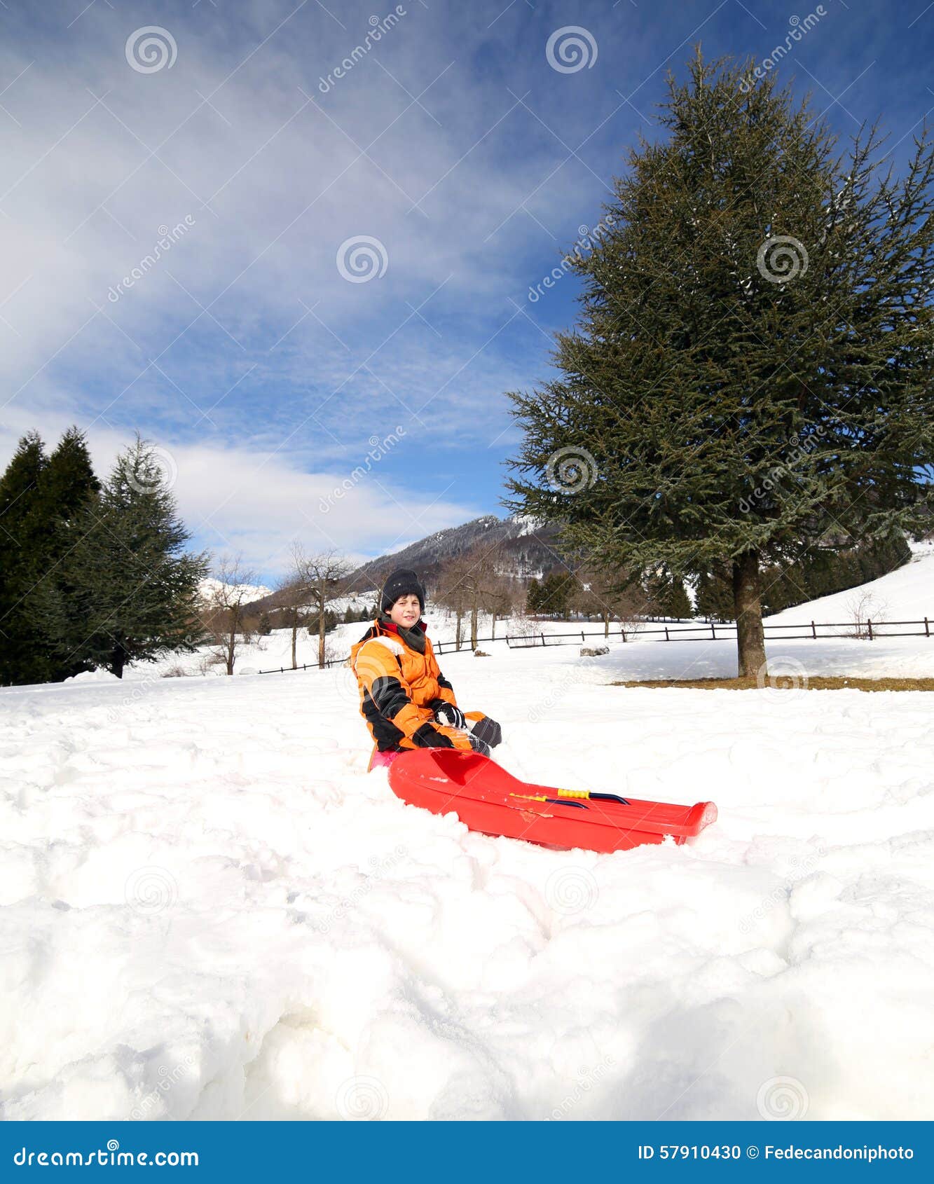 Child with Bob on the Snow in the Mountains Stock Photo - Image of ...