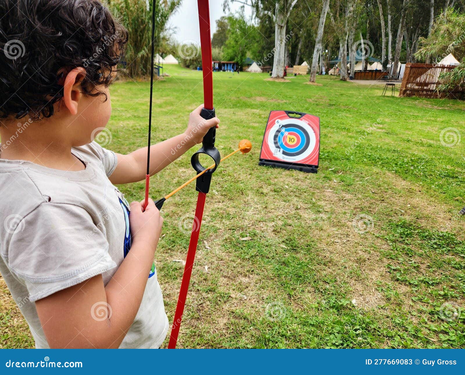 Child with bow and target stock image. Image of toddler - 277669083