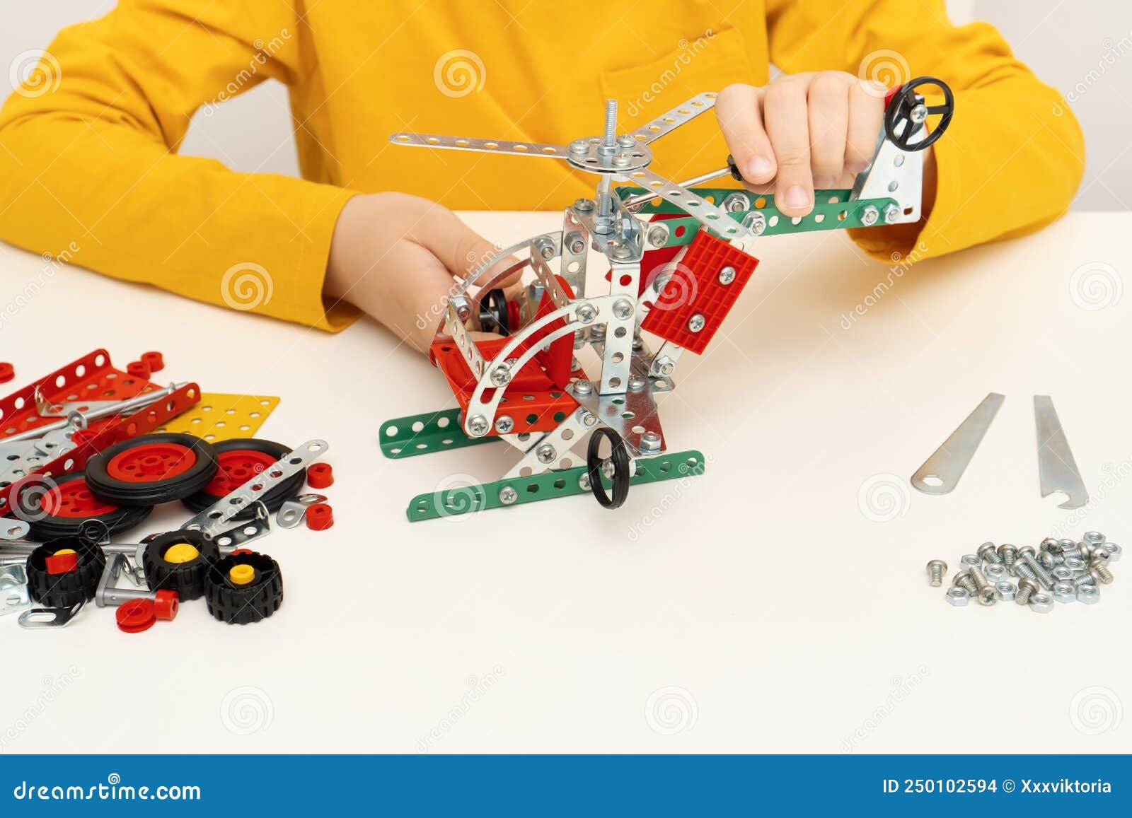 Child Boy Assembling Metal Model from Construction Kit Using Nuts ...
