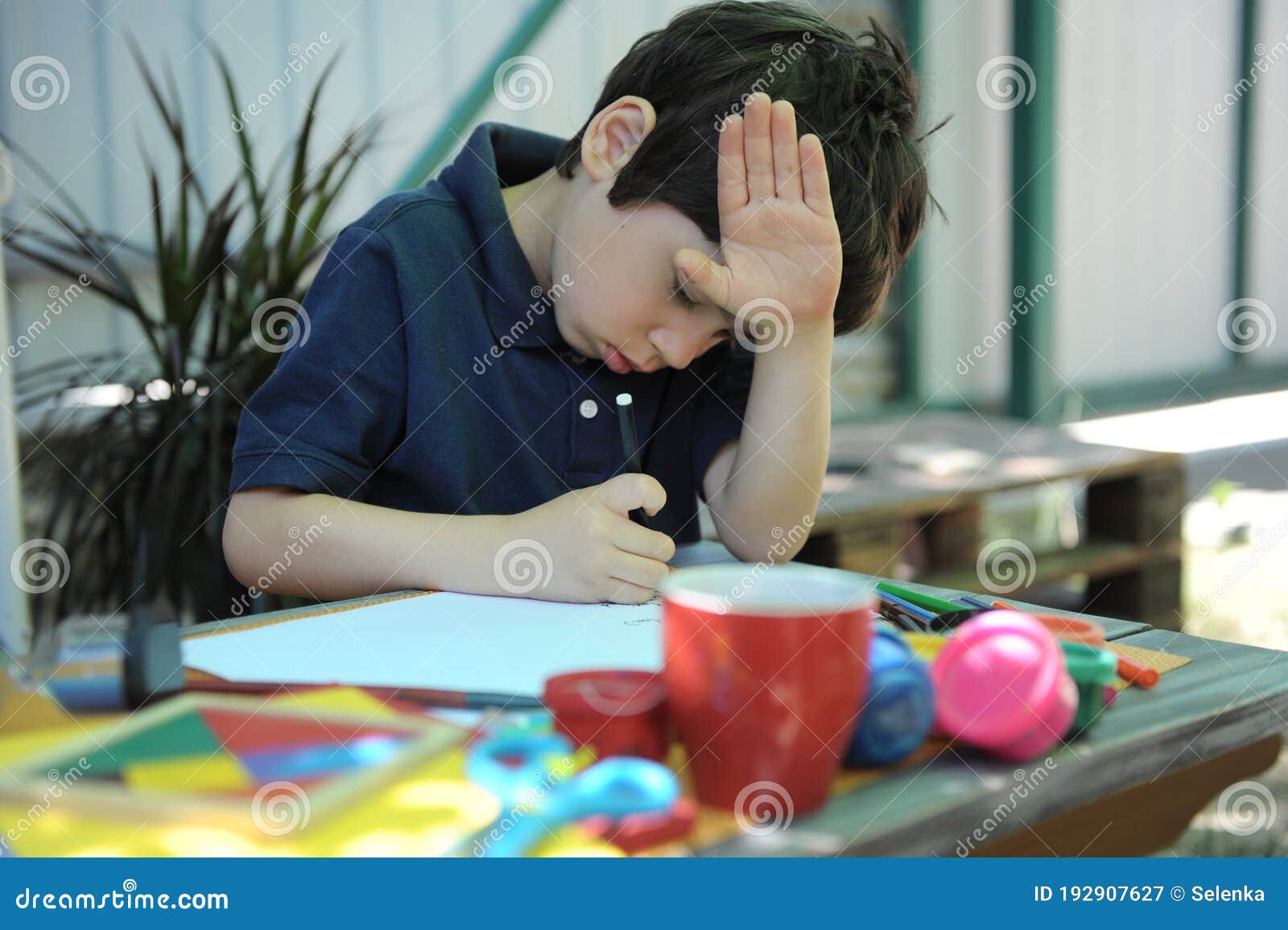 Child Boy Does His Homework at the Backyard and Showing Do Not Disturb ...