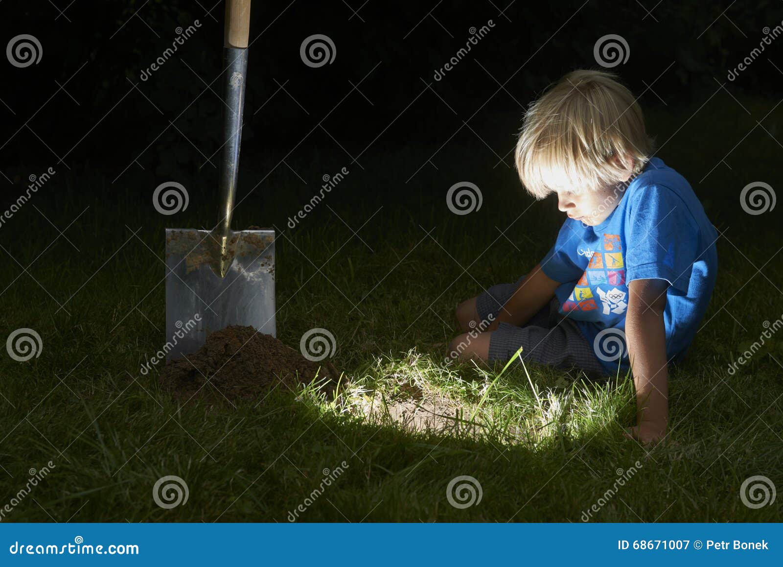 Child Boy Have Unearthed A Treasure In The Grass Stock Photo ...