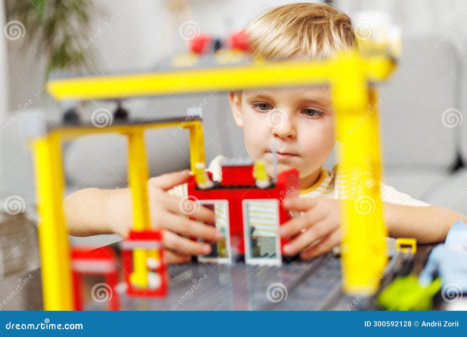 Child Boy Playing and Building with Colorful Plastic Bricks at the ...