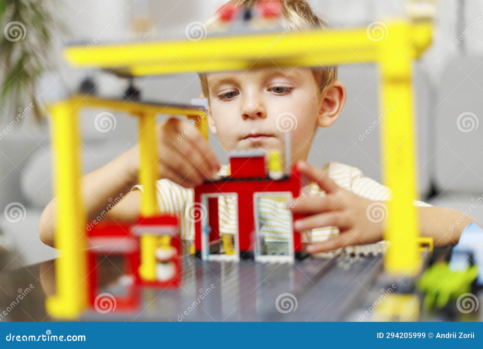 Child Boy Playing and Building with Colorful Plastic Bricks at the ...