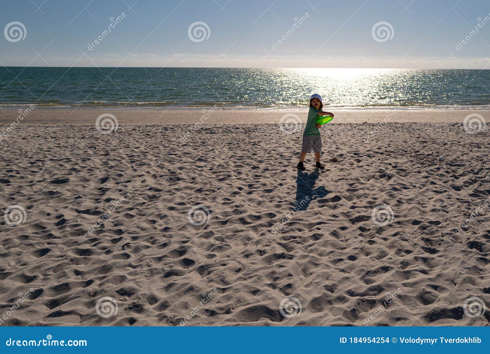 Child Boy is Playing with a Frisbee on the Beach. Boy Catching a ...